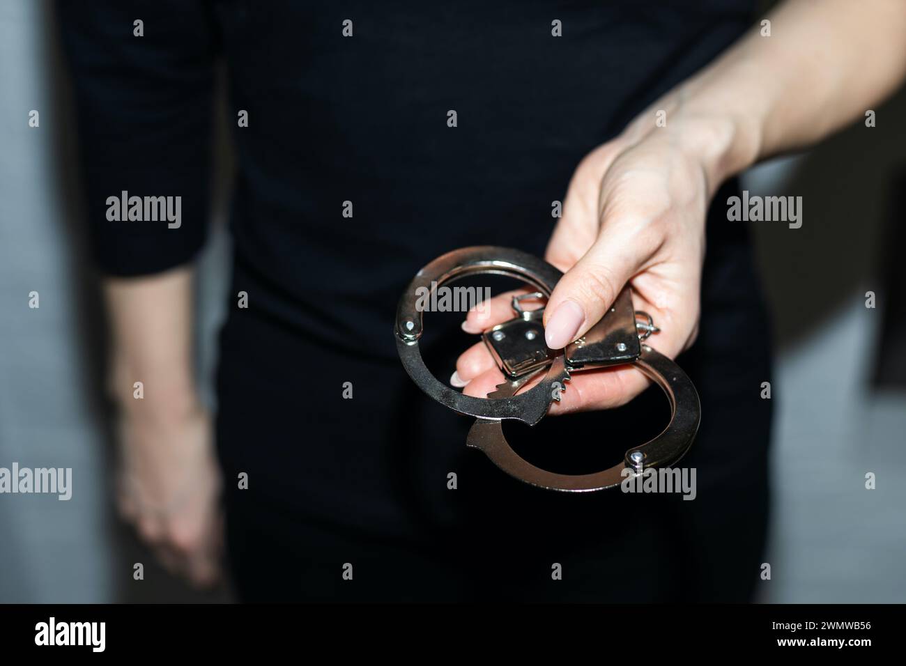 steel handcuffs of police special equipment, fetters on a black ...