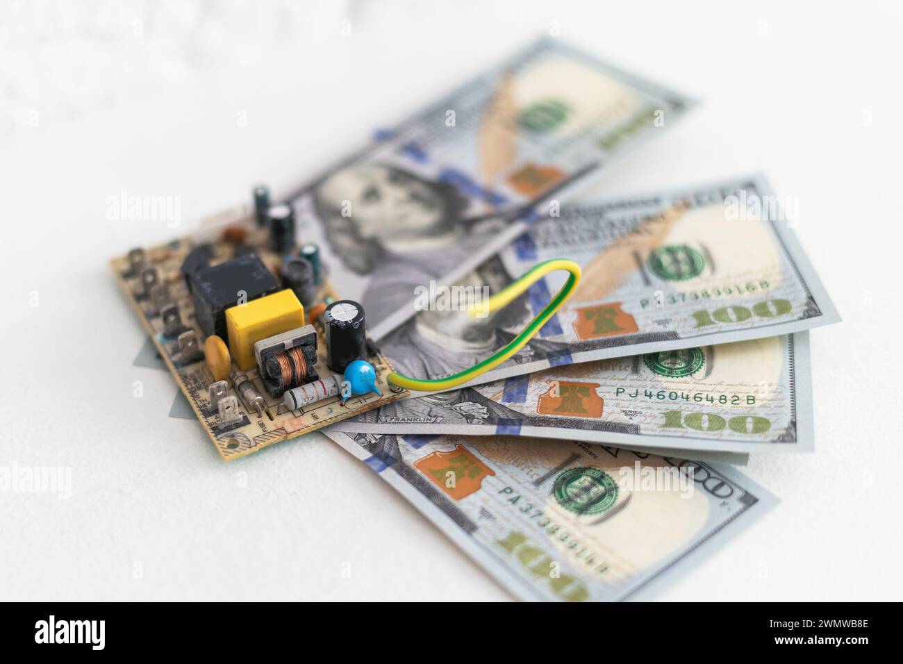 money and an electronic chip Stock Photo - Alamy