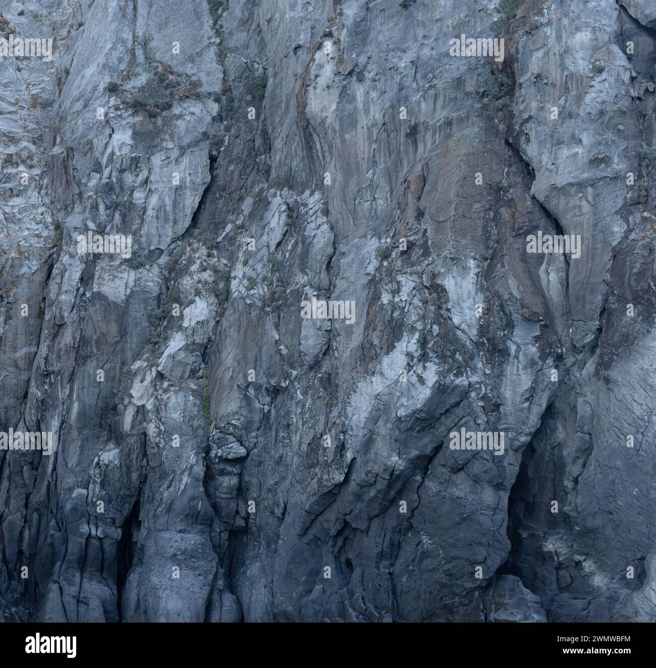 Weathered seaside rock face texture. Aged volcanic stone wall surface ...