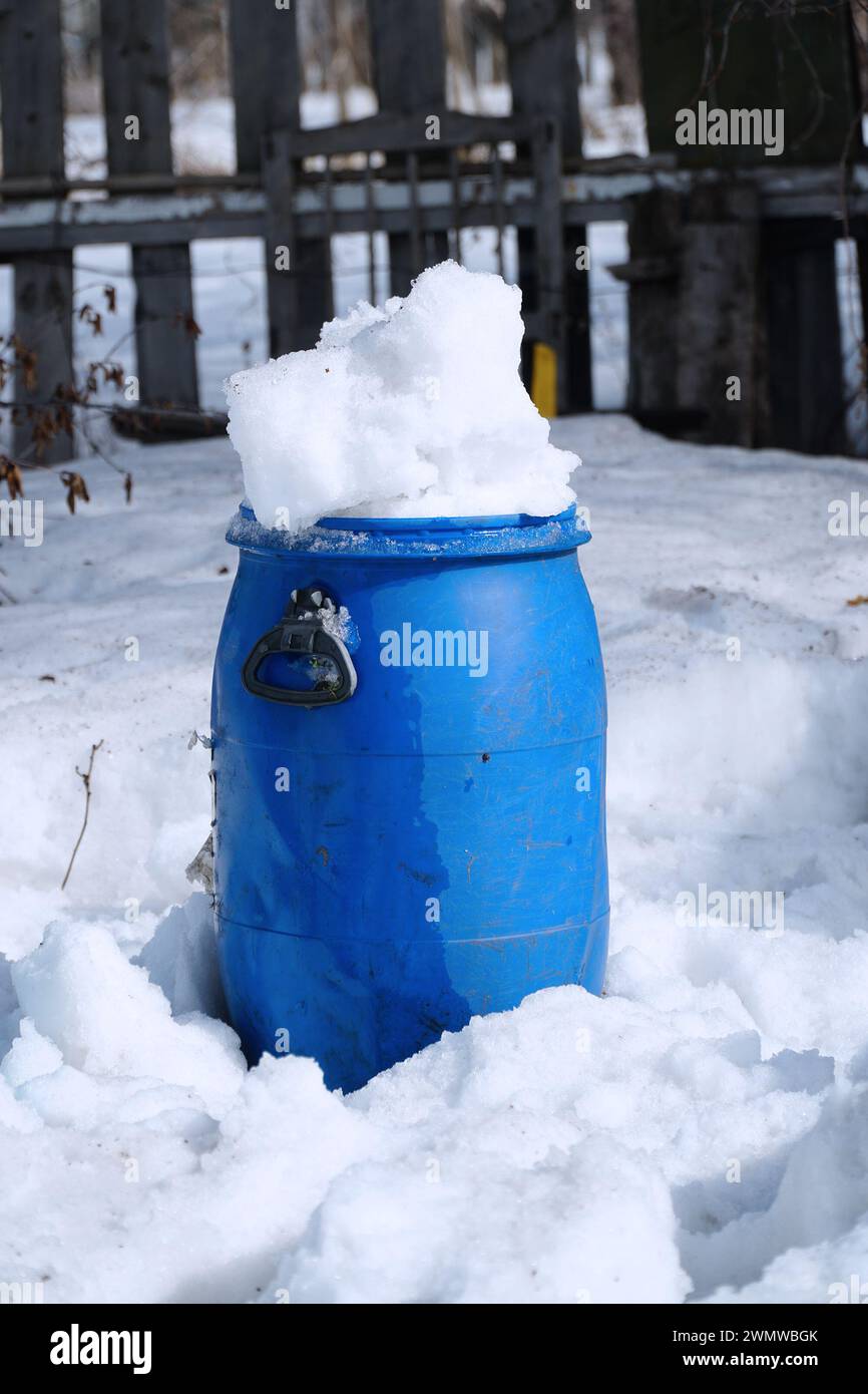 Melting spring snow in the garden in a barrel. Selective focus Stock ...