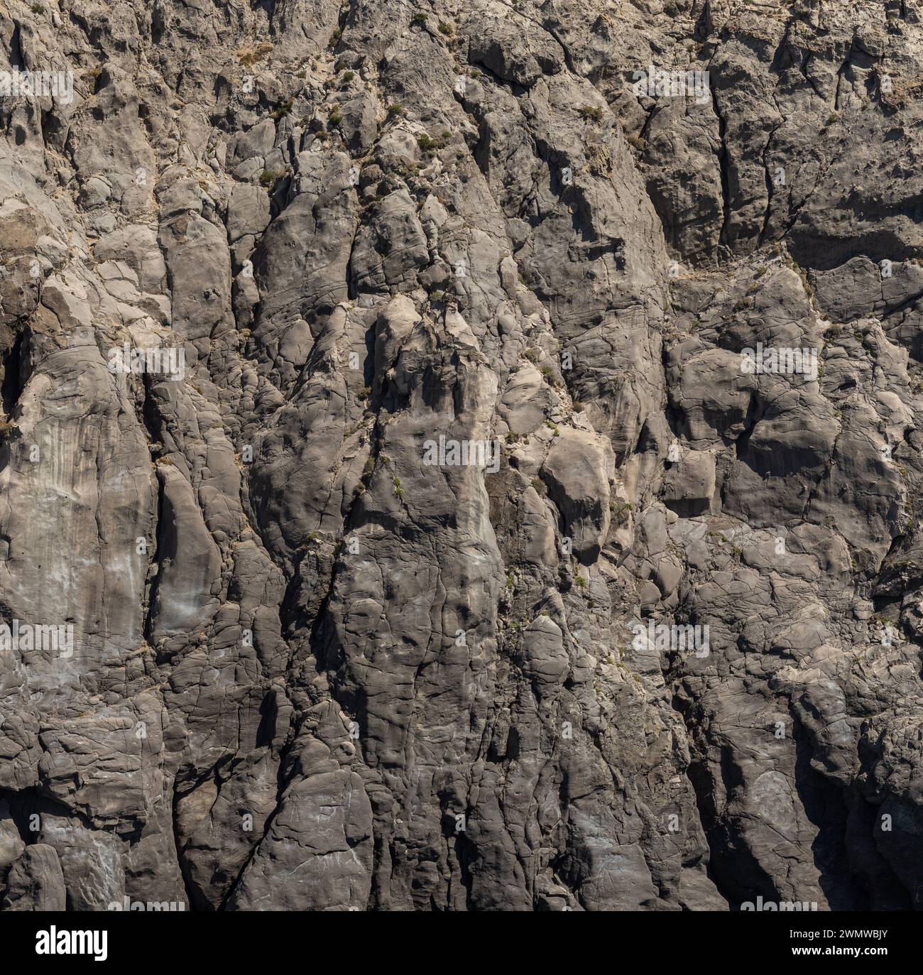 Weathered seaside rock face texture. Aged volcanic stone wall surface ...