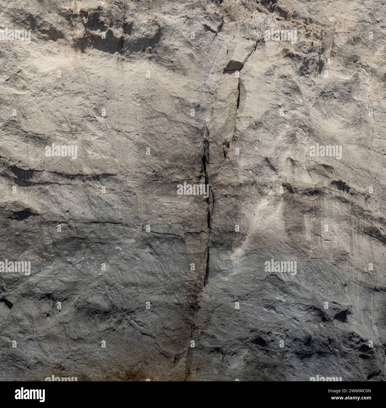 Weathered seaside rock face texture. Aged volcanic stone wall surface ...