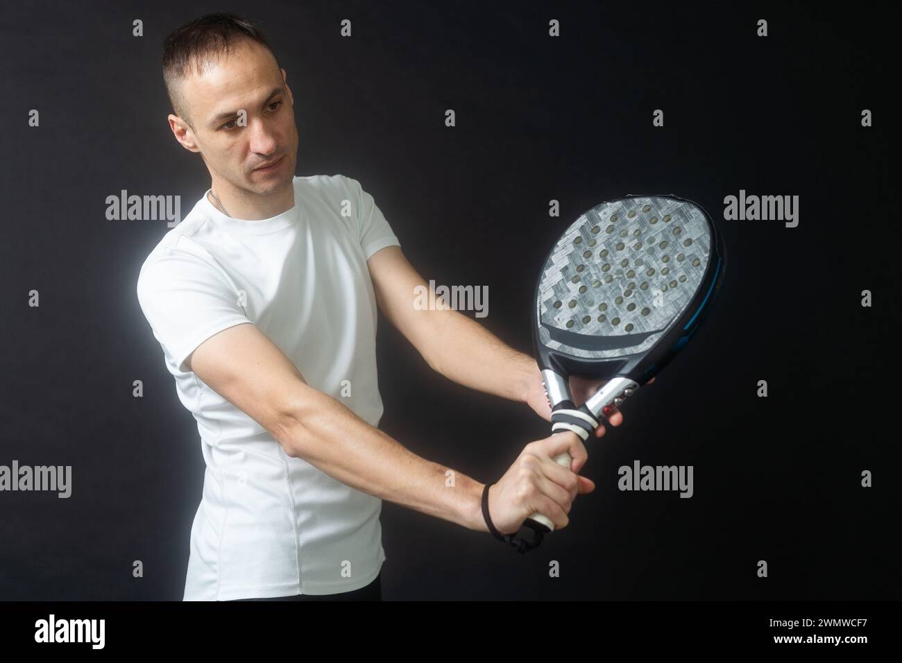 Padel Tennis Player with Racket in Hand. Paddle tennis, on a black ...
