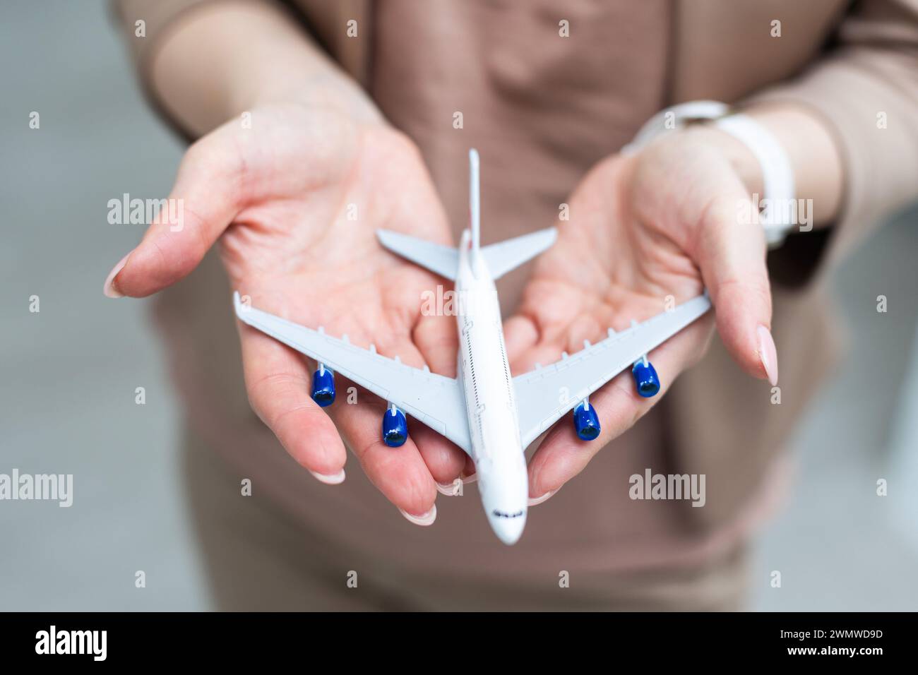 Female woman hands holding small toy model plane. Travel by plane ...