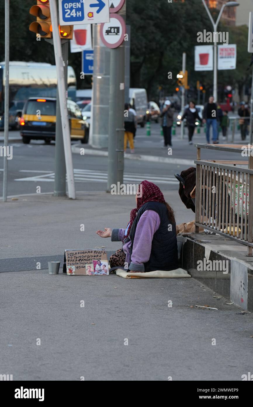 Homeless woman on pavement hi-res stock photography and images - Alamy