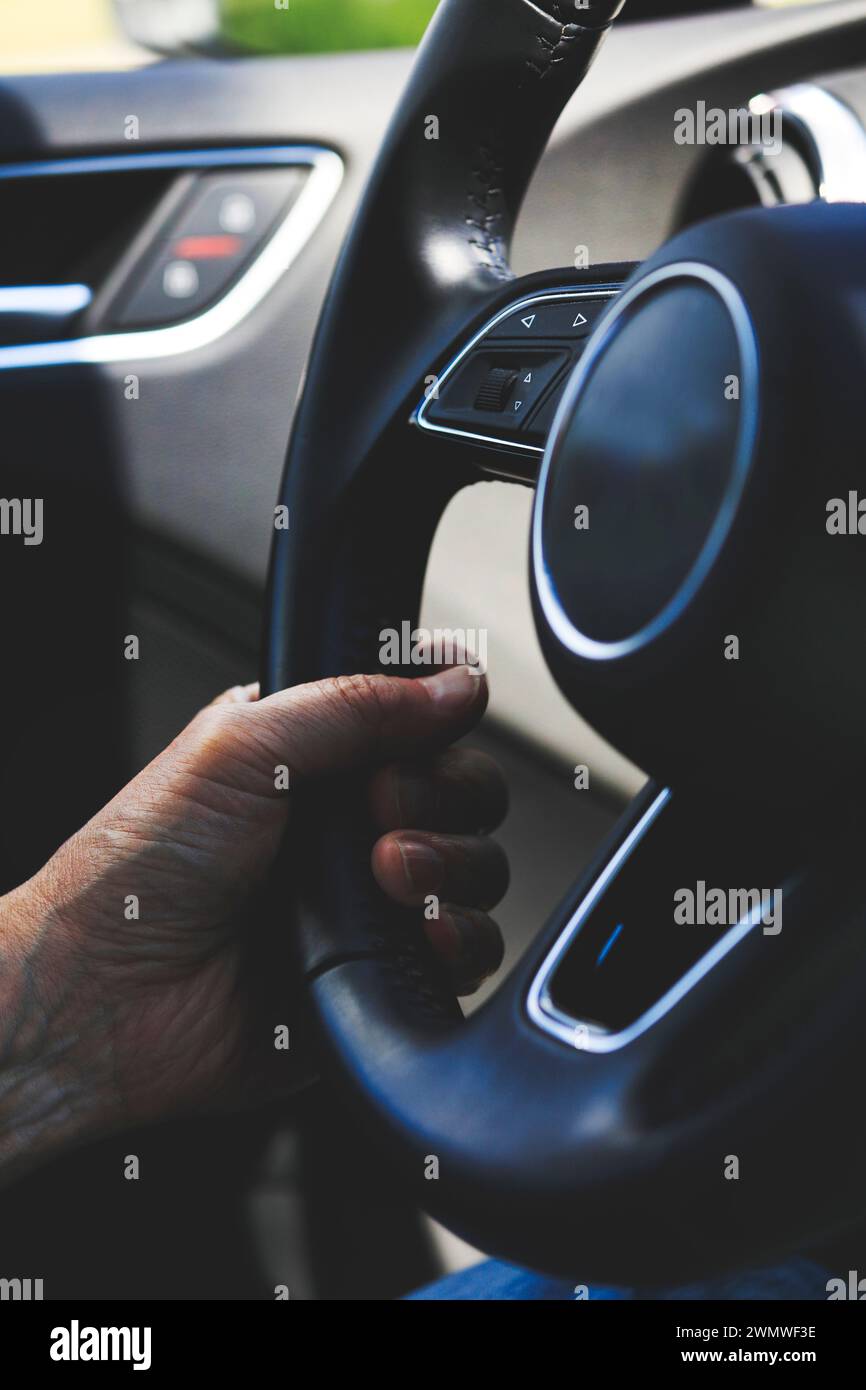 Driver - Hand of a Male Holding Steering Wheel of the Car, vertical ...