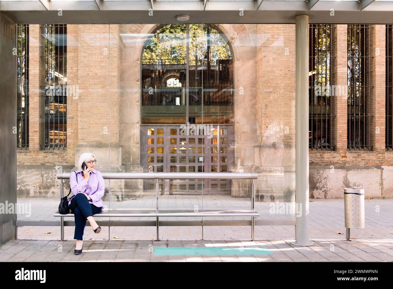 Elderly lady waiting bus stop hi-res stock photography and images - Alamy