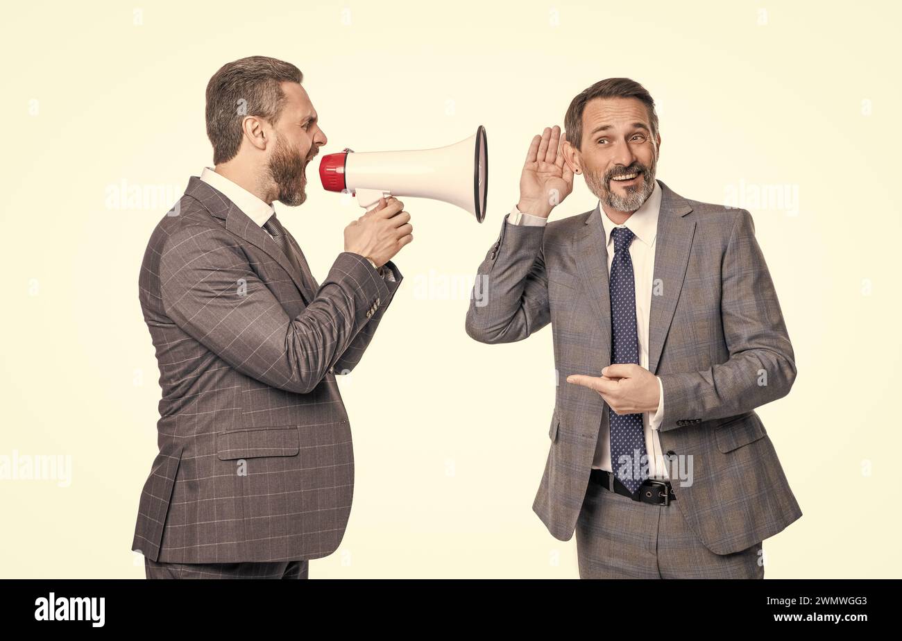 businessmen ignore shouting pointing on loudspeaker. two businessmen ...