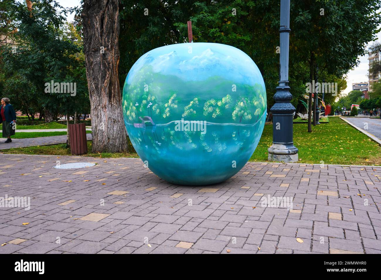 A large, giant painted apple with a famous location of the city, one of ...