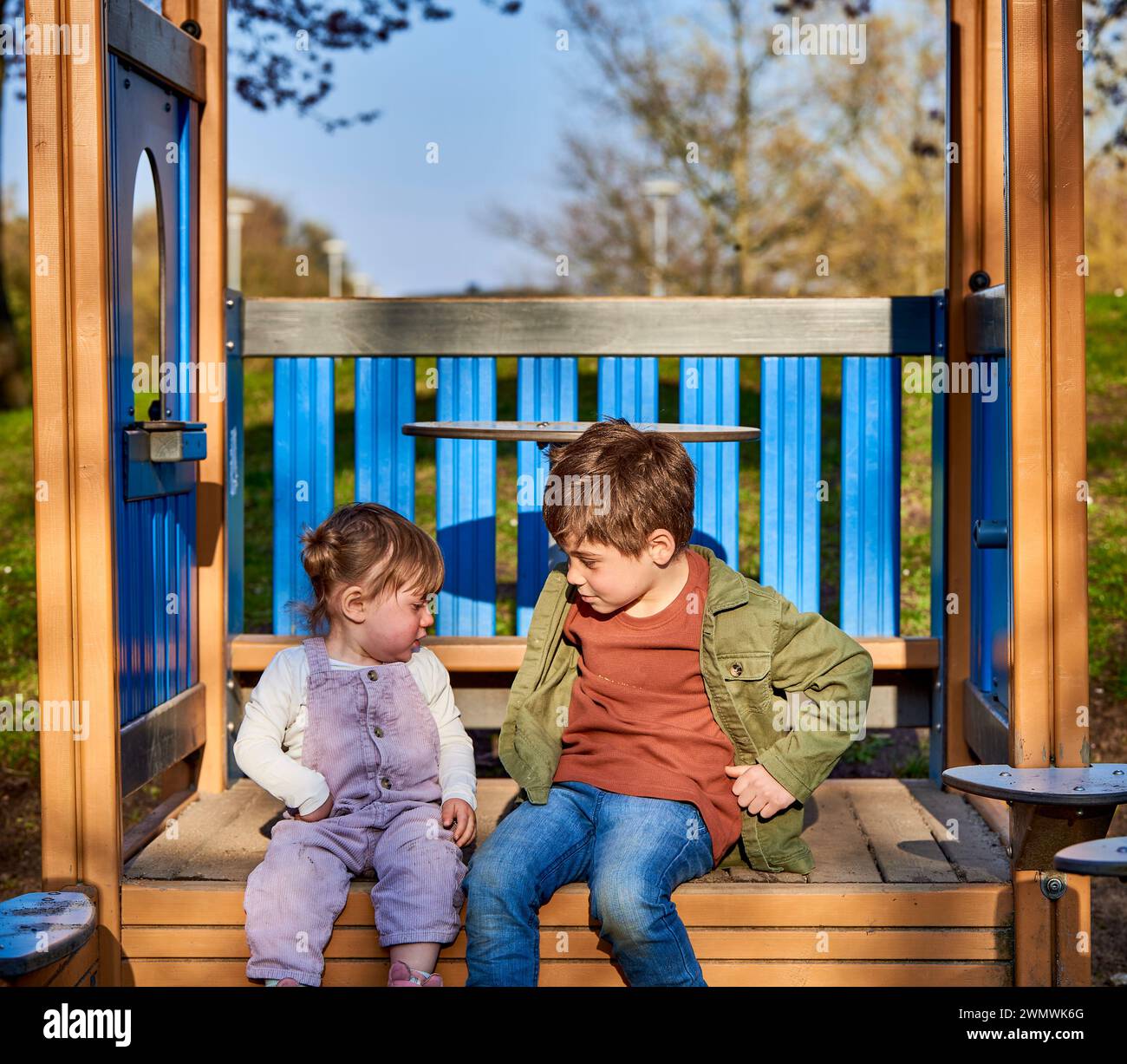 On a sunny day, cheerful children brother and sister looking at each ...
