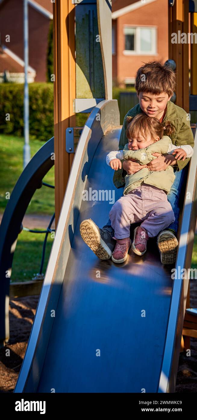 Child going down playground slide hi-res stock photography and images ...