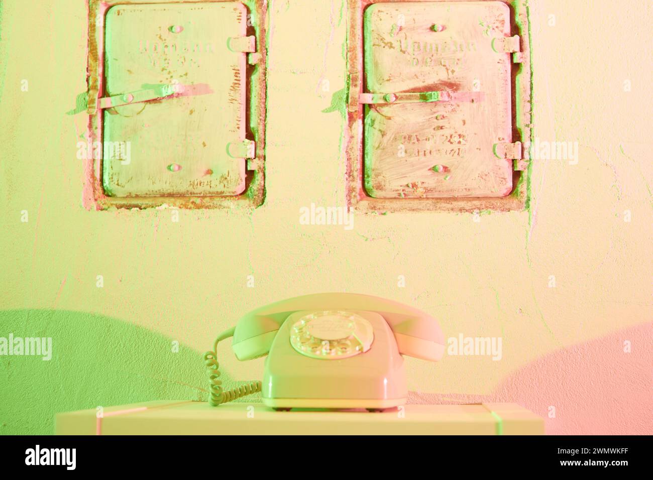 old telephone with a separate receiver and rotary dial on a board in ...