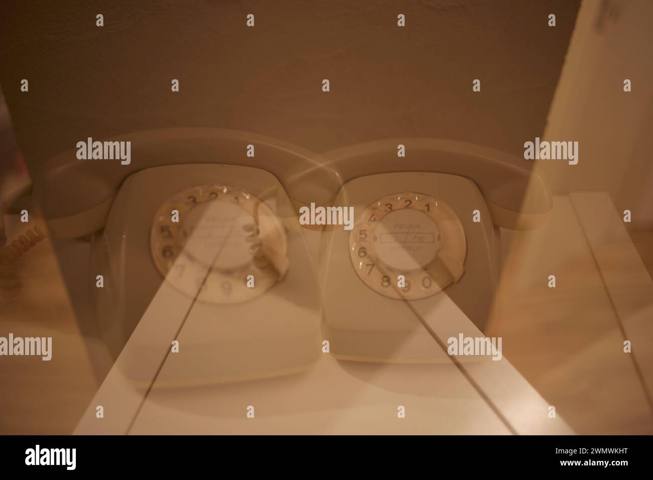 old telephone with a separate receiver and rotary dial on a board ...