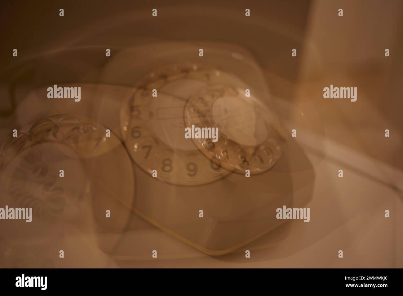 old telephone with a separate receiver and rotary dial on a board ...