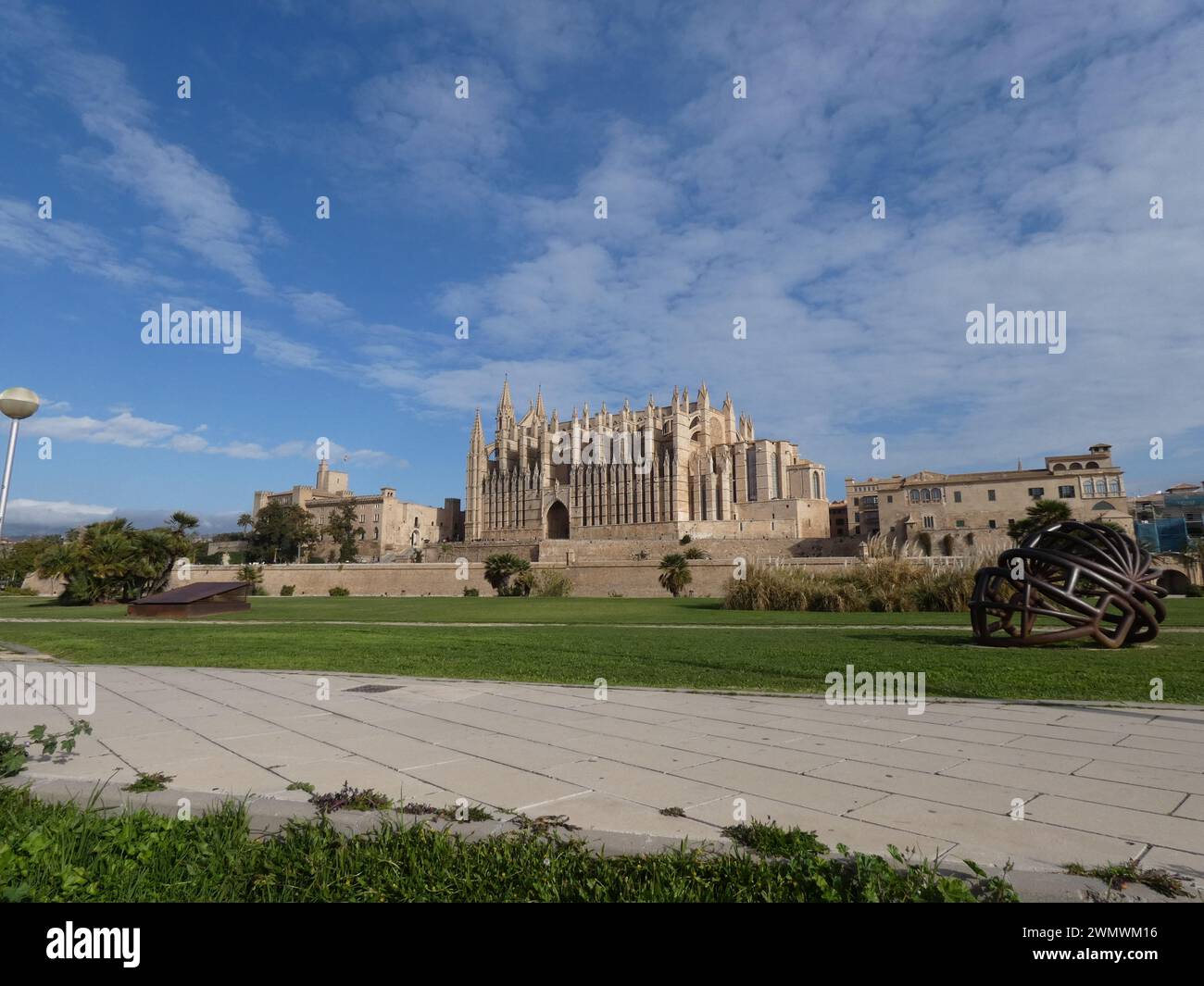 A grand building with a massive stone sculpture in its front garden ...