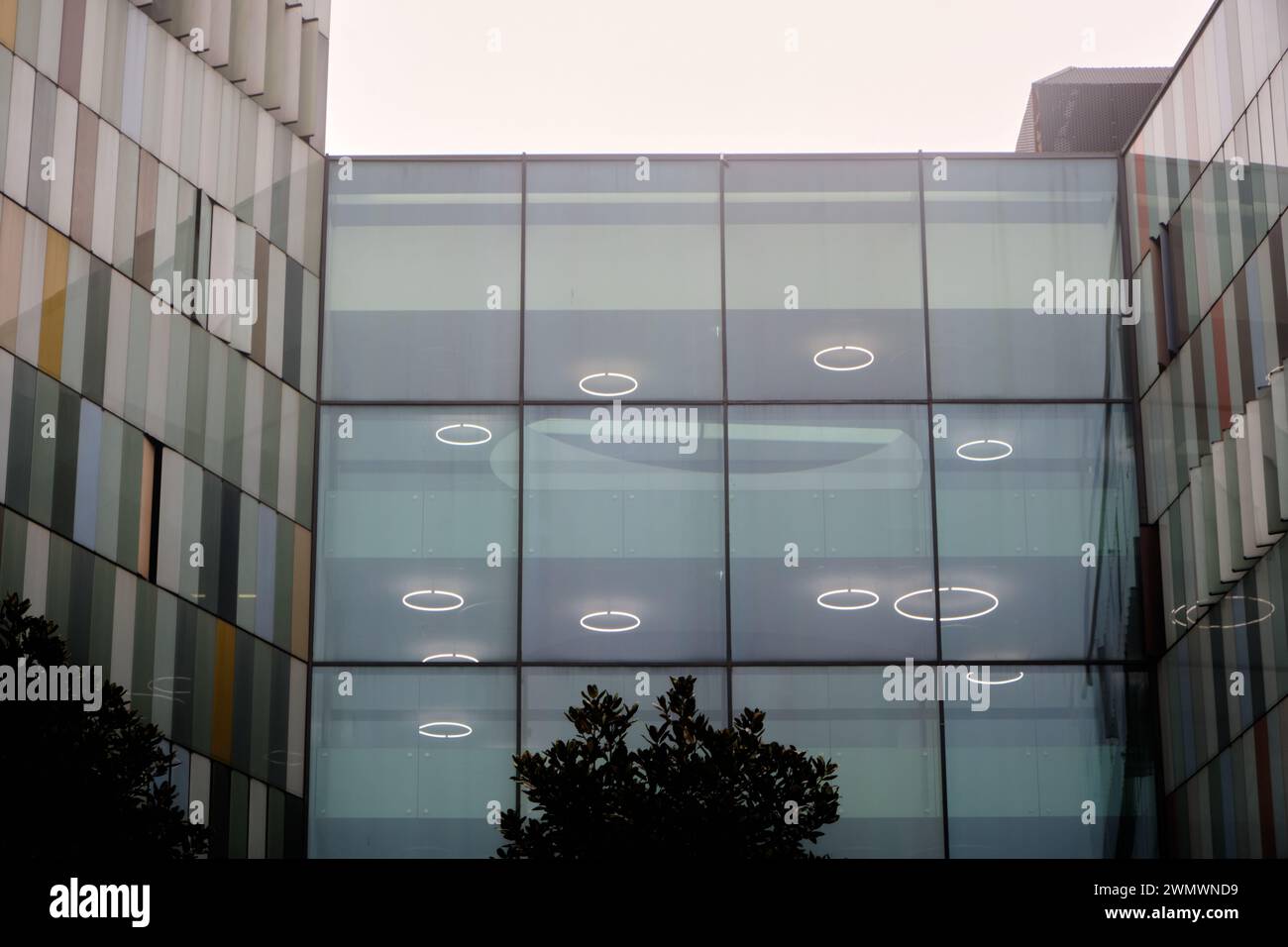 modern building features circular LED chandeliers and expansive glass ...