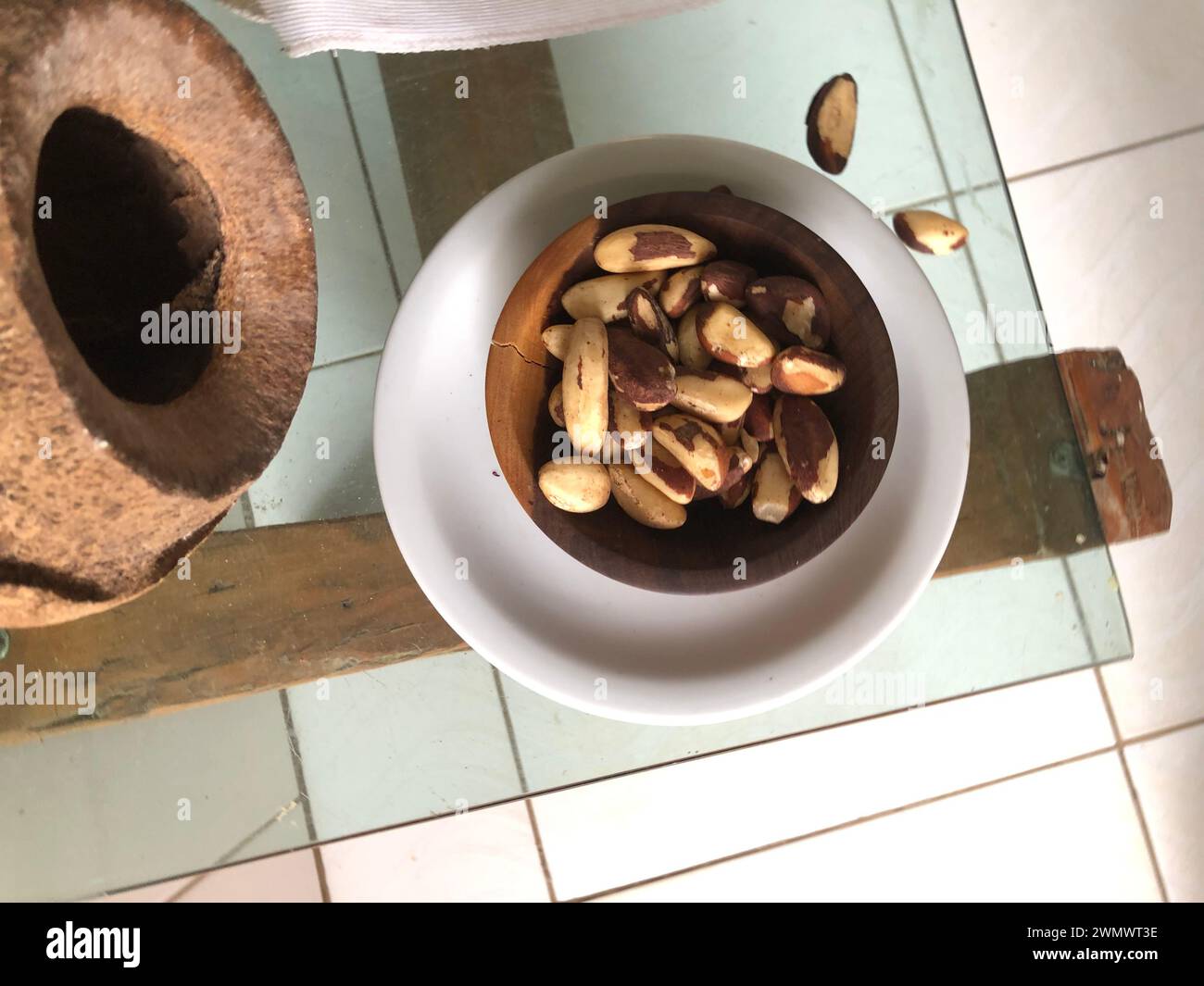Brazil nuts on the glass table, known as "Castanha do Pará".Bowl of ...