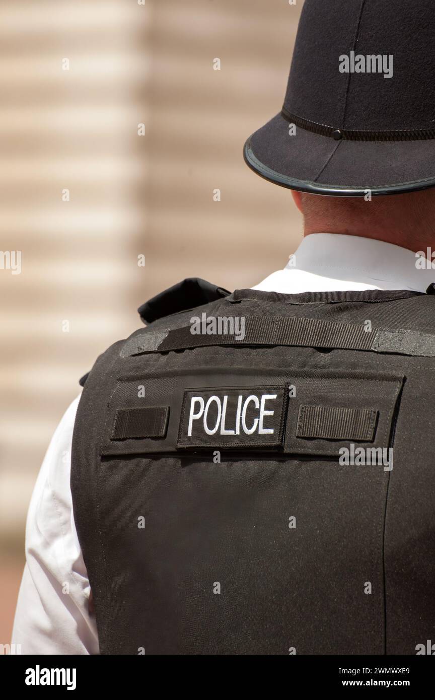 LONDON, UK - JULY 03, 2010: Closeup of Policeman wearing helmet with ...