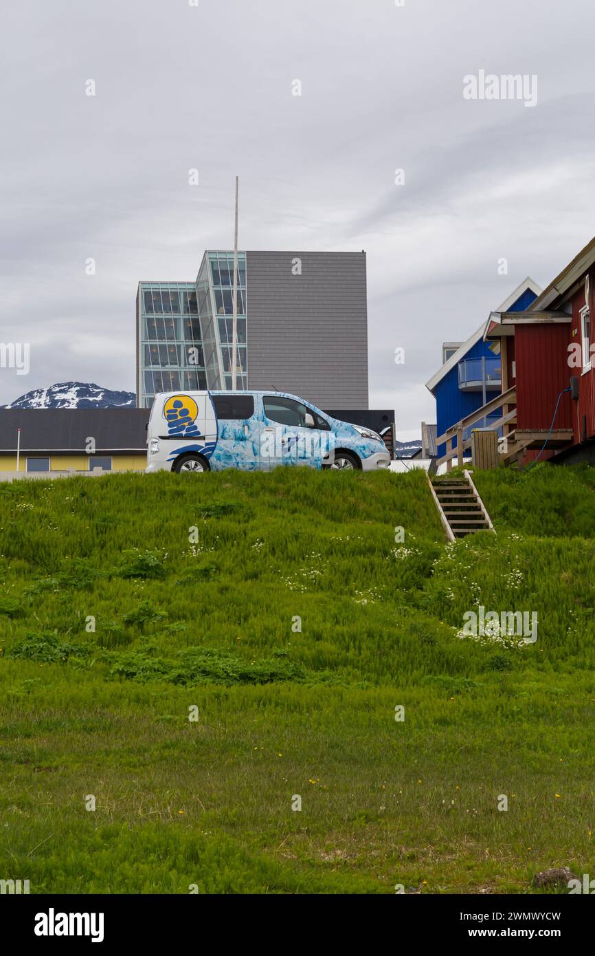 electric vehicle being charged with tallest building in Greenland the ...