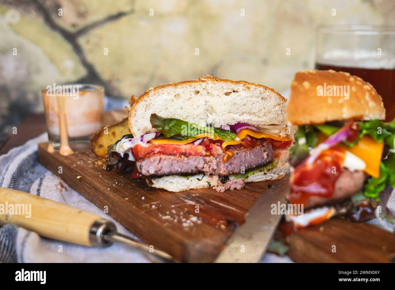 Gourmet split hamburger, fries and beer; appetizing composition, fast ...