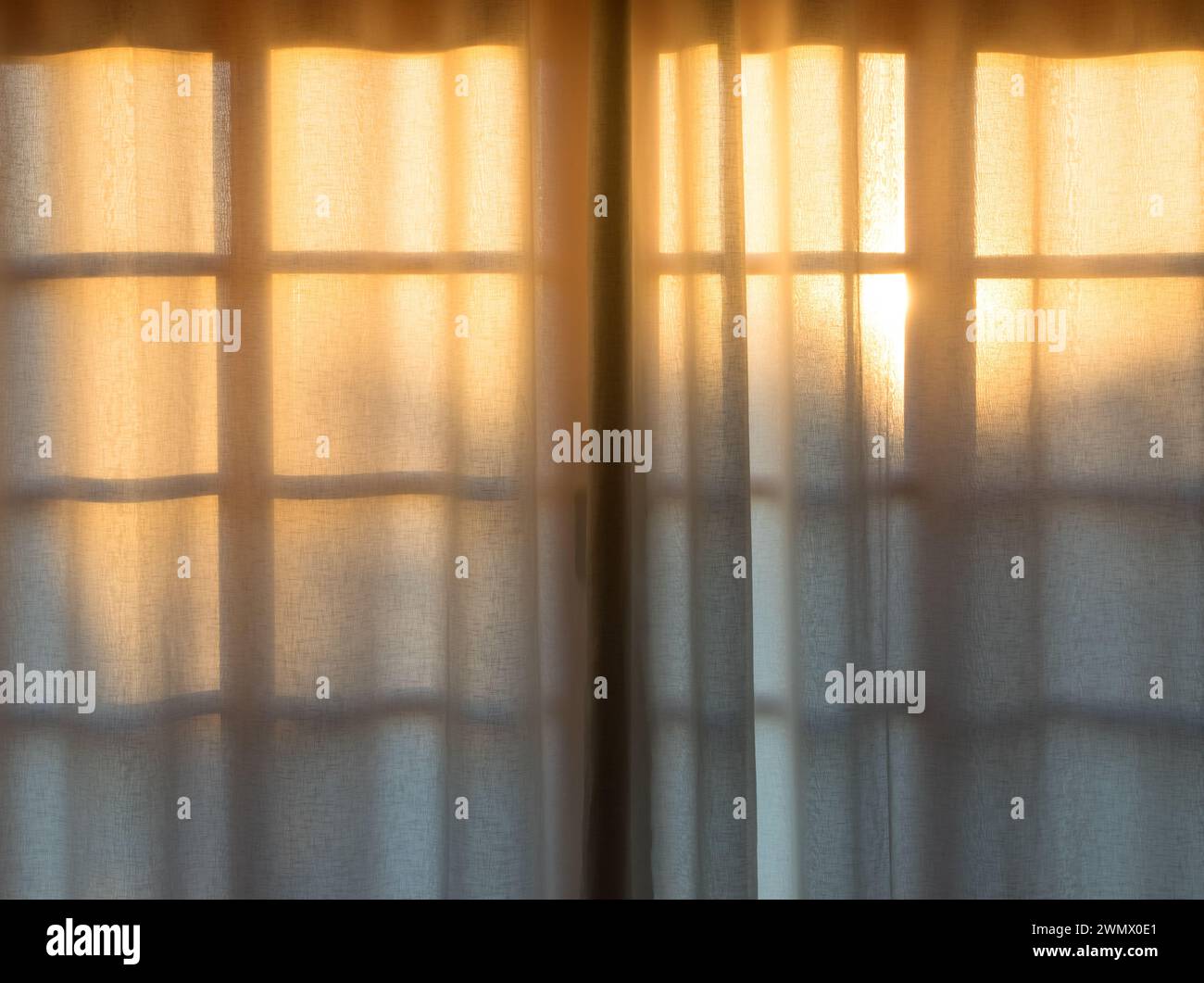 The sunset behind a window with a curtain Stock Photo - Alamy