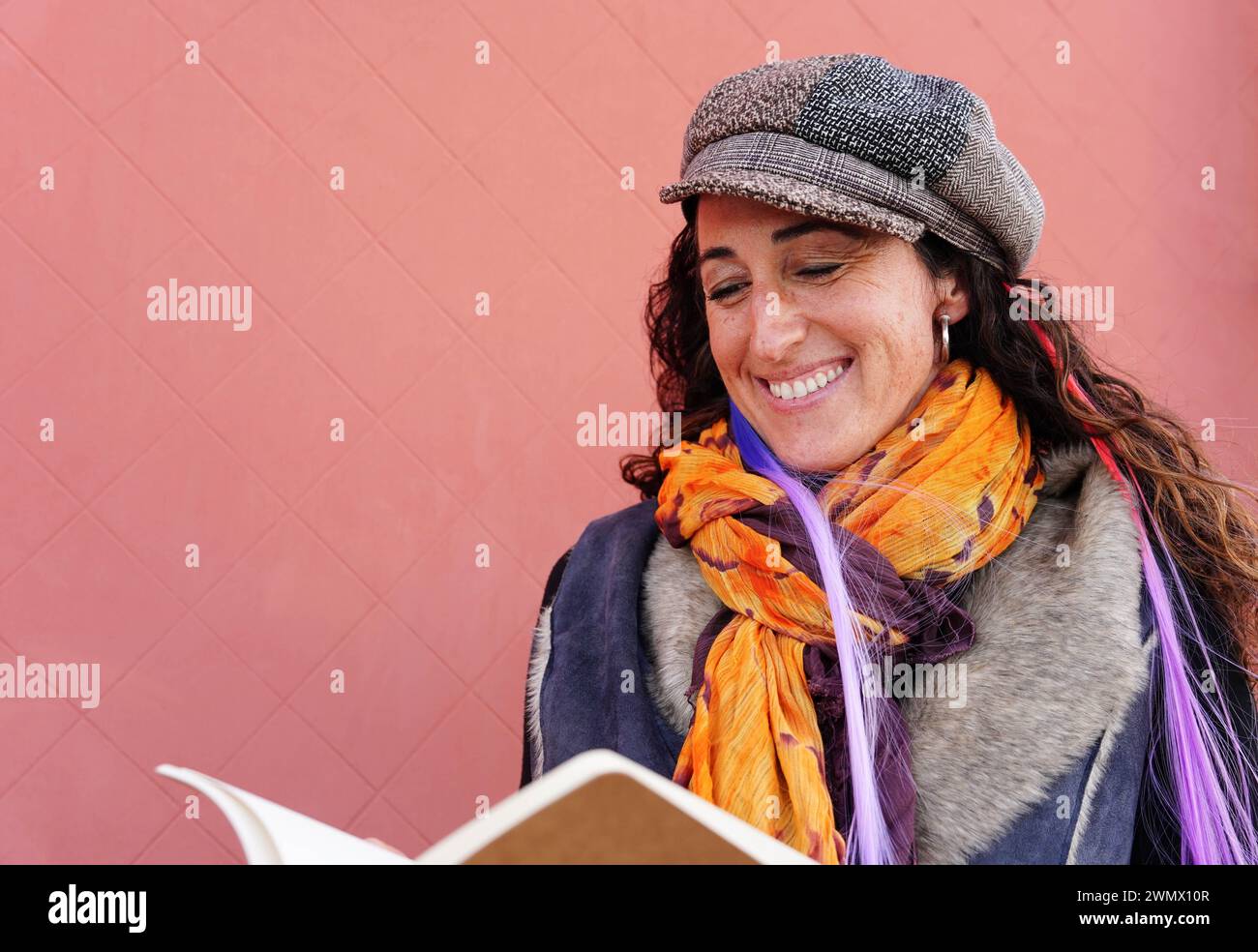 a stylish mature woman reading a book outside. world book day. sant ...
