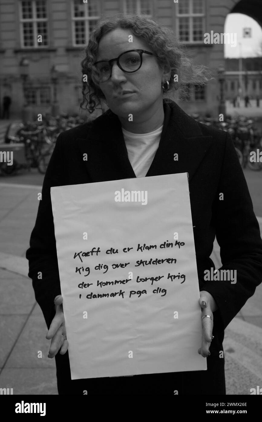 Rosa Lund of the the Red Green Alliance is holding a sign with a hate ...