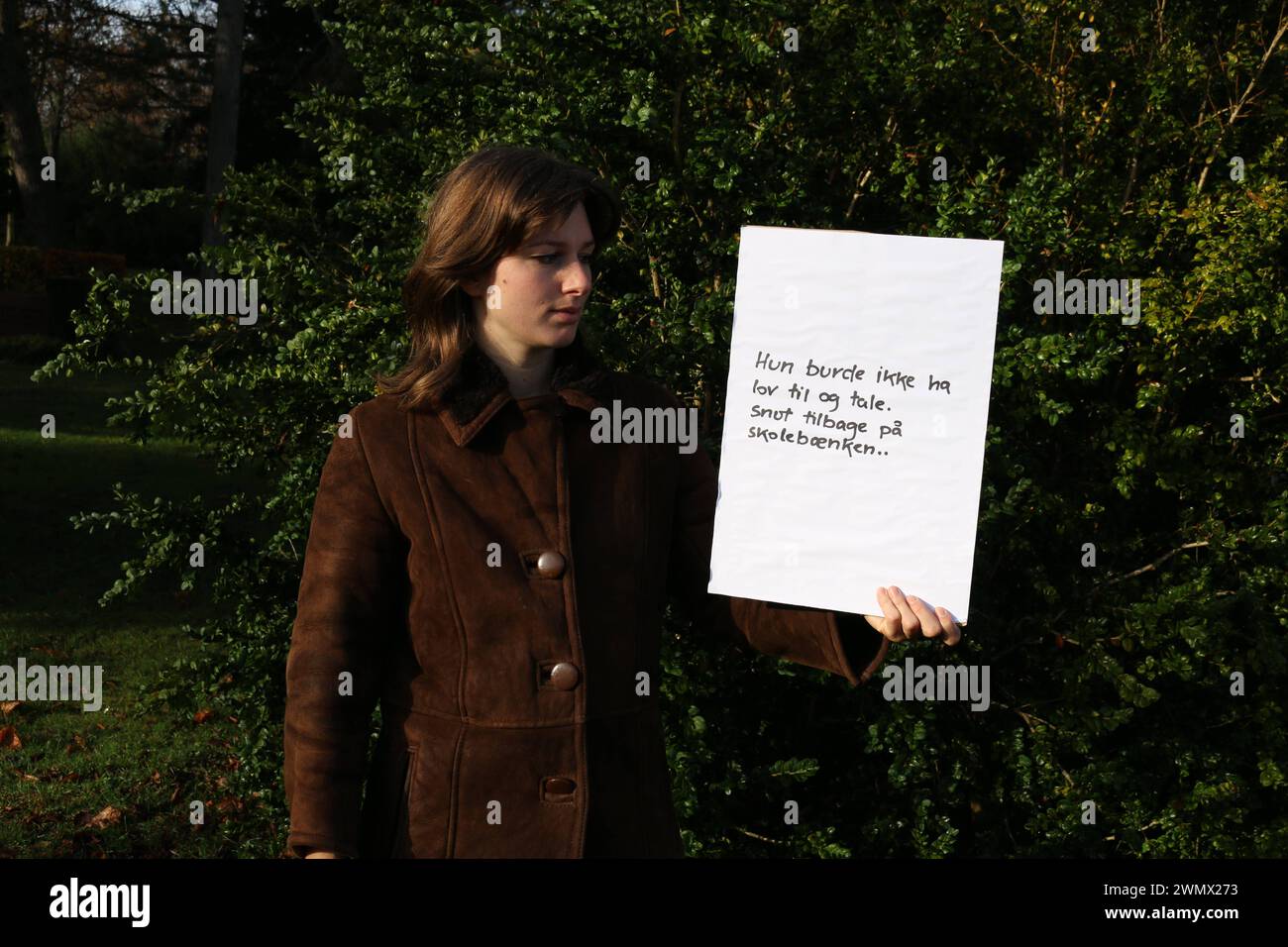 Esther Kjeldahl, philosopher and climate activist, is holding a sign ...