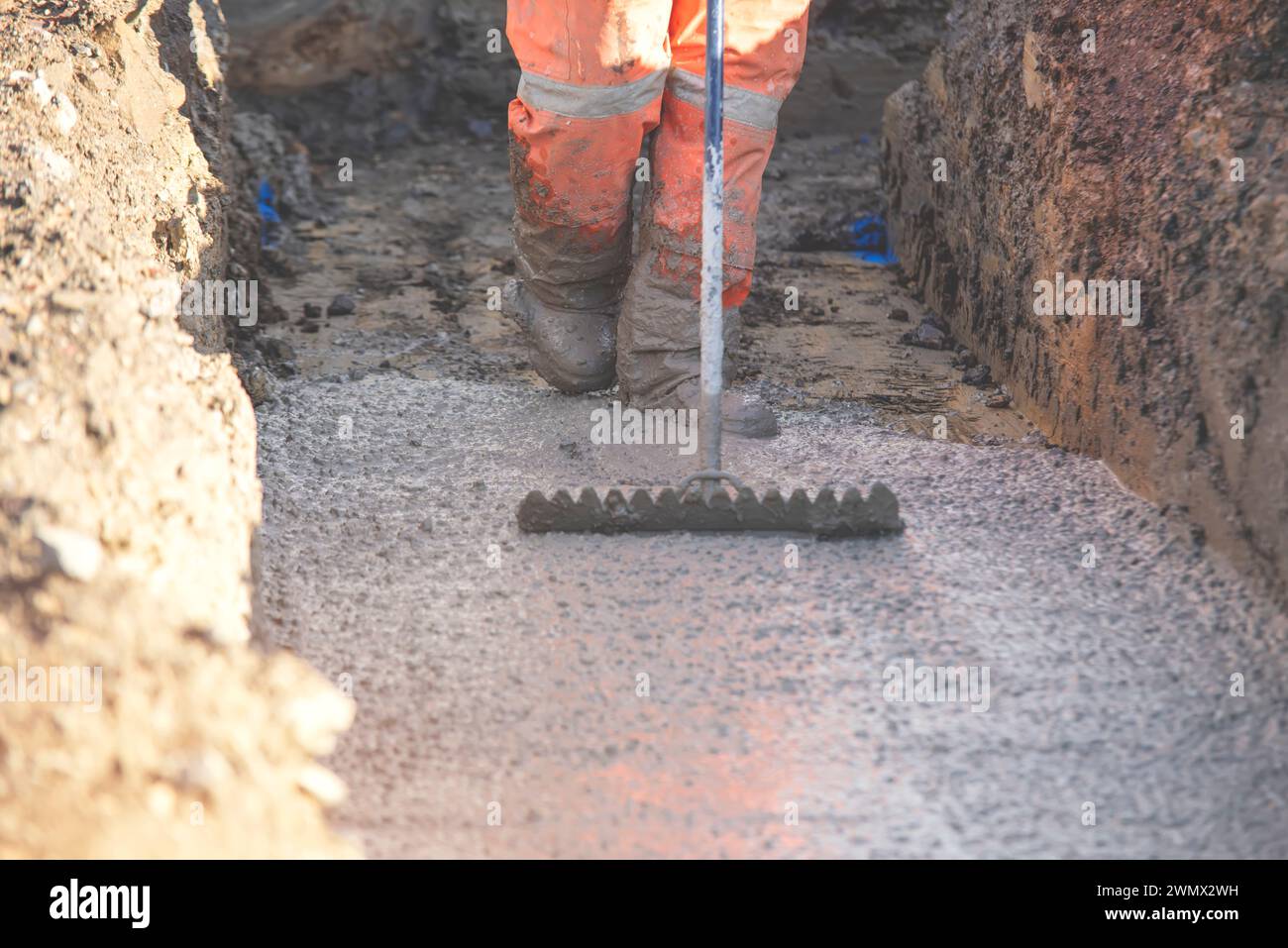 Concrete cast-in-place work. Builder leveling wet concrete. Concrete ...