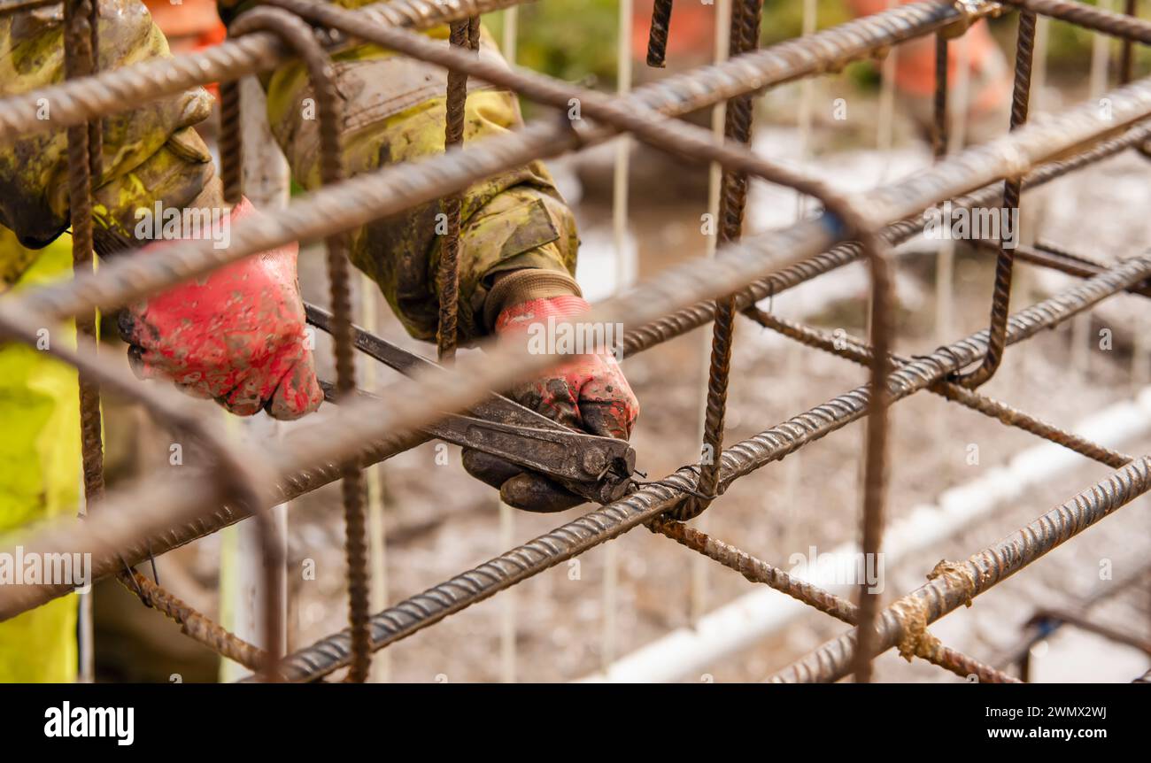 Construction worker steel fixer working at the building site close-up ...
