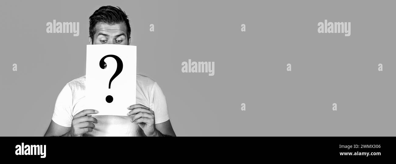 Man holding a question mark in front of his head, psychology concept ...