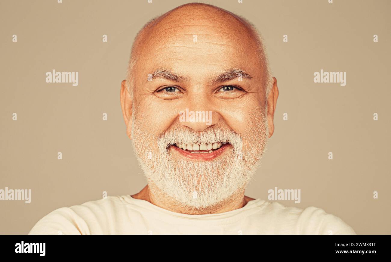 Older grandfather, grandpa pensioner, retiree concept. Mature man. Close up face of handsome ...