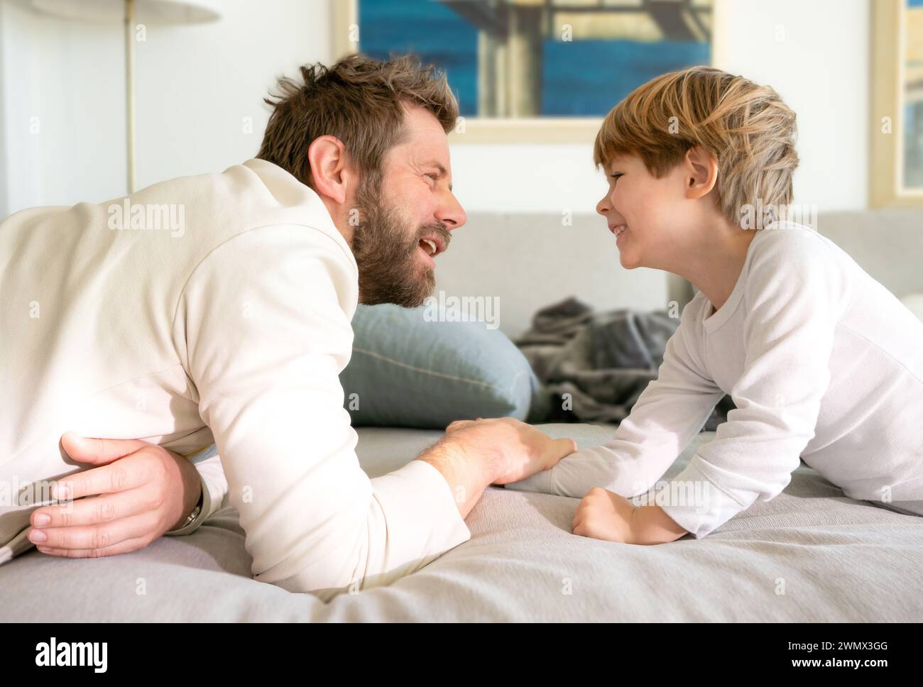 Little champion. Side view of happy father and son competing in arm ...