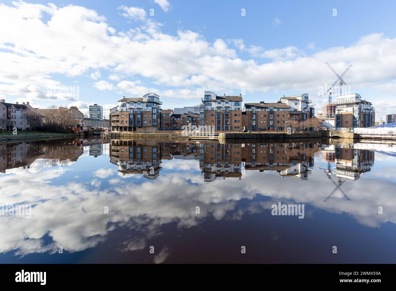 A mirror like reflection of clouds on the Water of Leith, Edinburgh ...