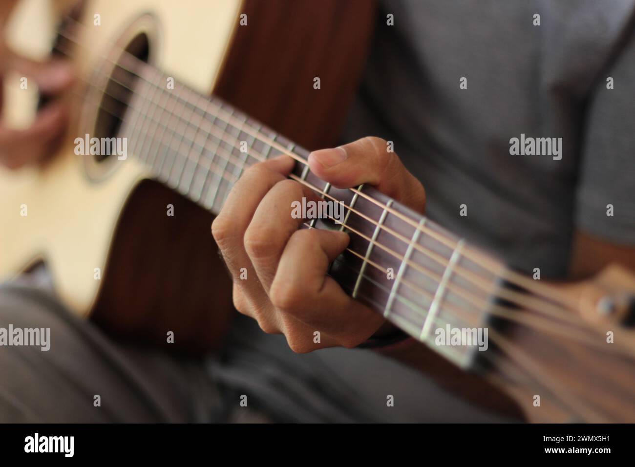 A close-up shot captures the emotive artistry of hands playing an ...