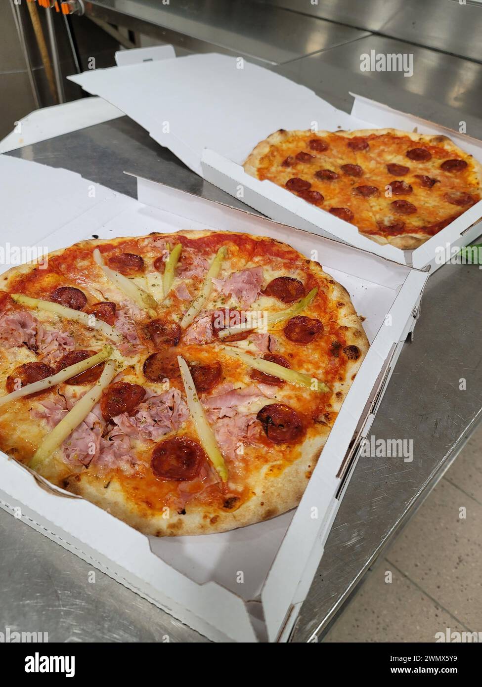 Two pizzas in boxes on a counter with handles, ready for delivery Stock ...