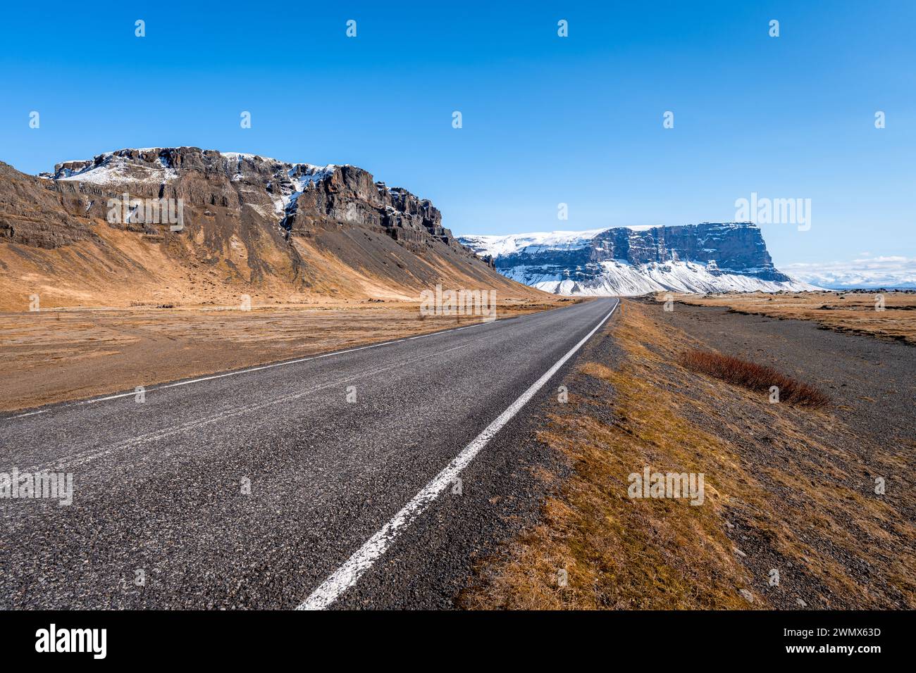 Scenic country road with stunning cliffs backdrop in Iceland Stock ...