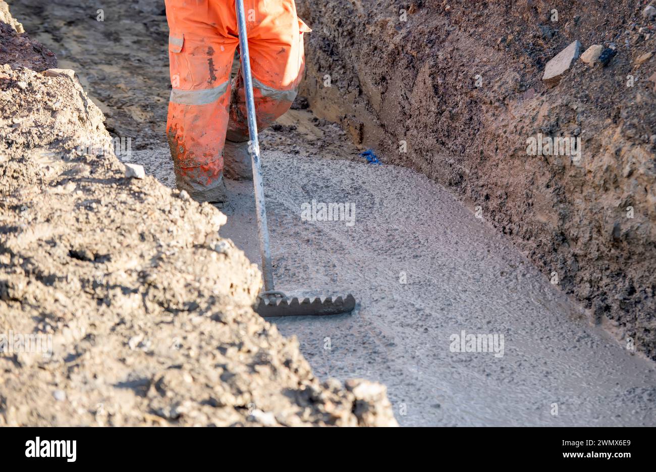 Concrete cast-in-place work. Builder leveling wet concrete. Concrete ...