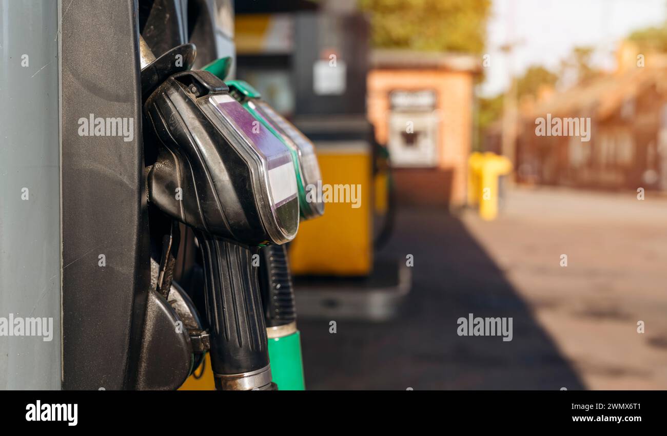 Close up of diesel and petrol fuel pistols at a gas station. The fuel ...