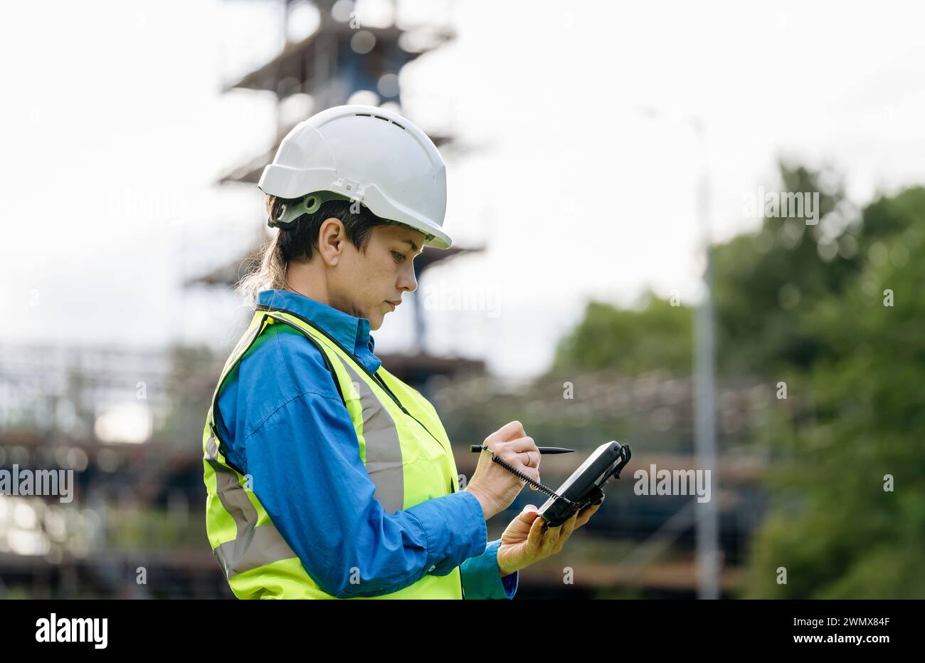 Female site engineer surveyor working with theodolite total station EDM ...