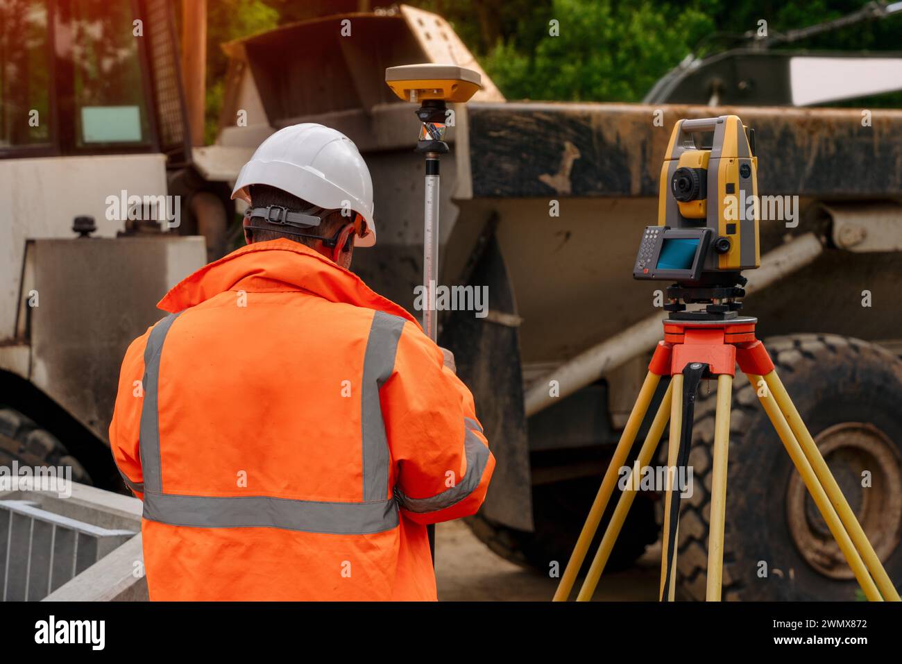 Surveyor site engineer with total positioning station on the ...