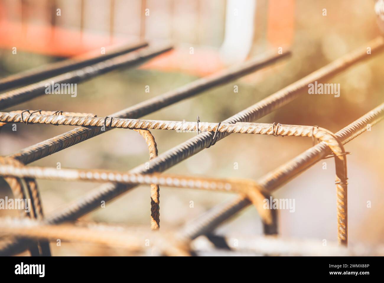 A worker uses steel tying wire to fasten steel rods to reinforcement ...