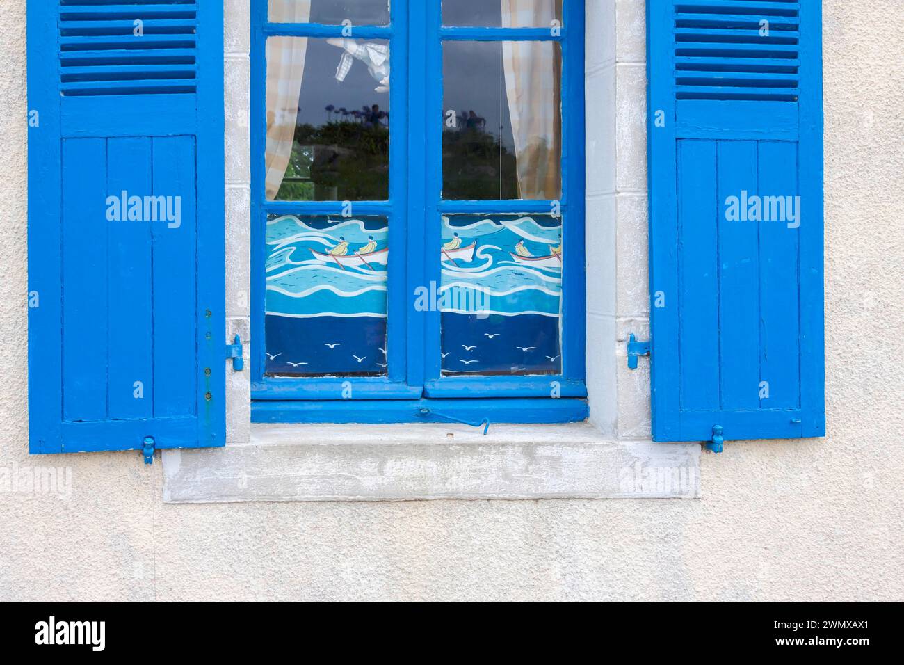 Windows, blue window frames and blue shutters, with decorative film as ...