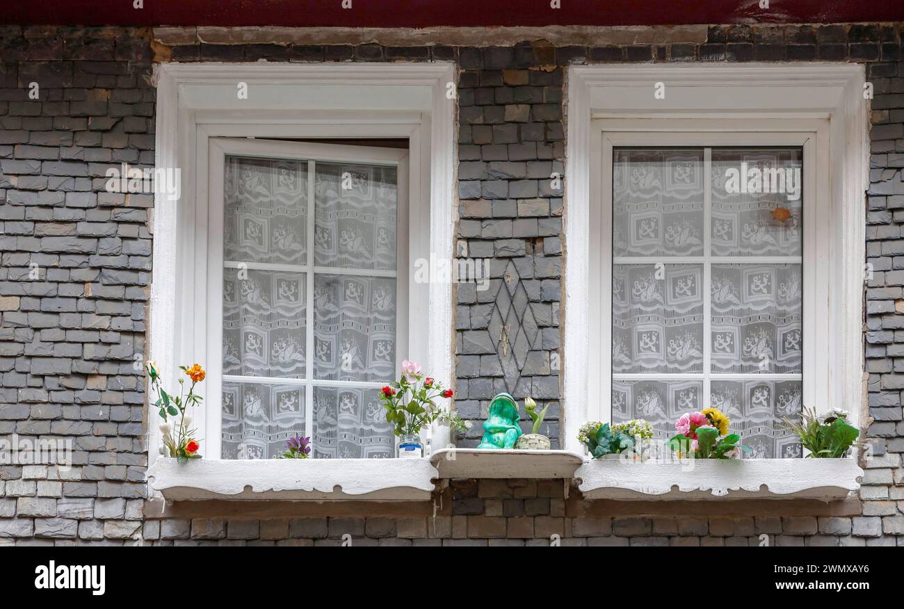 Slate-clad house facade, two windows and decoration made of artificial ...