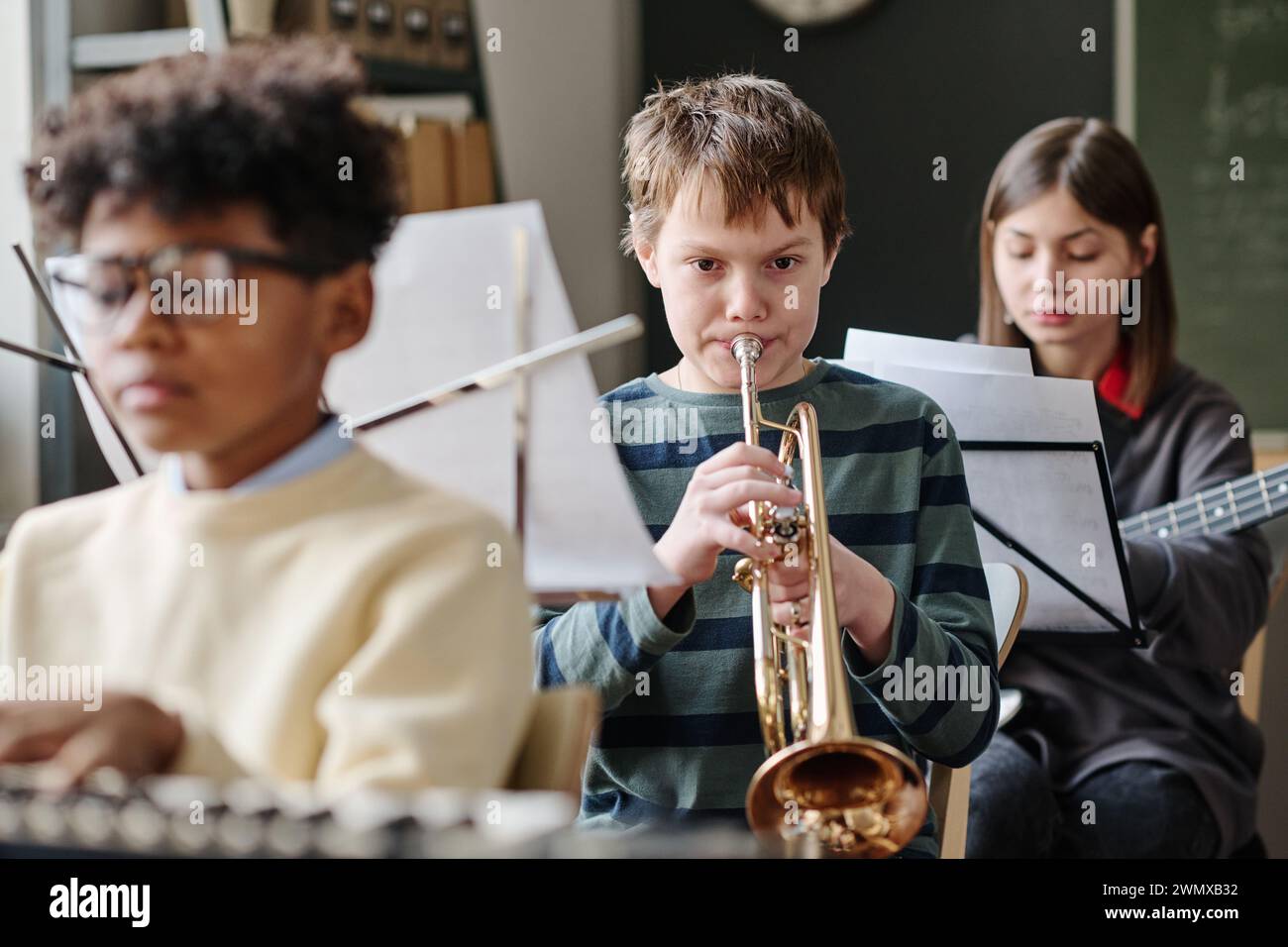 Playing the trumpet in music class hi-res stock photography and images ...