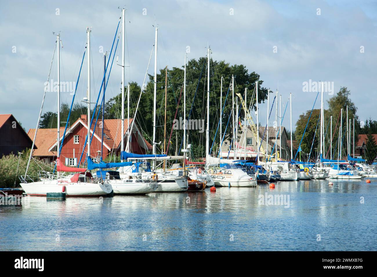 The early Autumn view of sailboats on a shore of Minija River that ...
