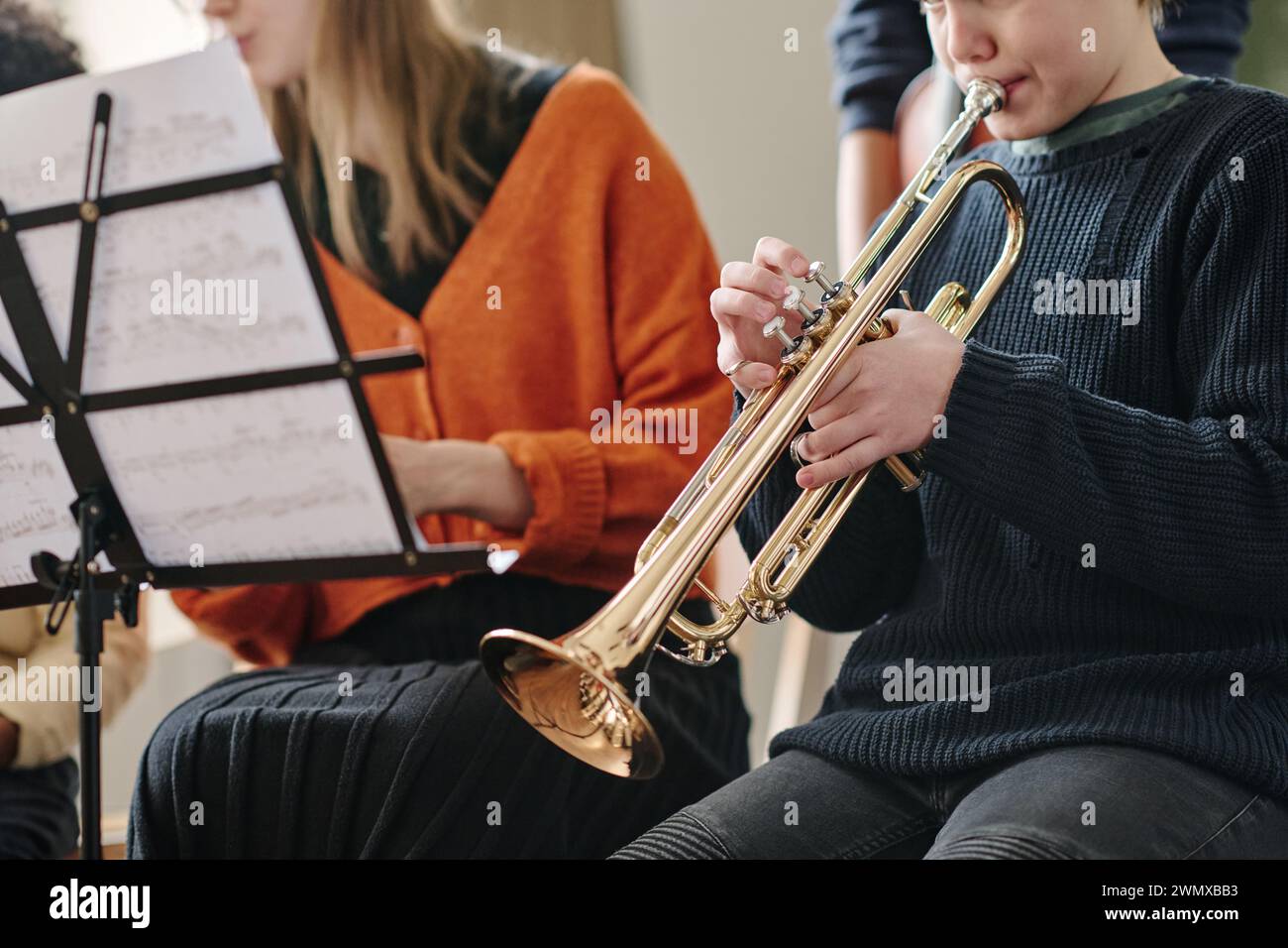 Playing the trumpet in music class hi-res stock photography and images ...