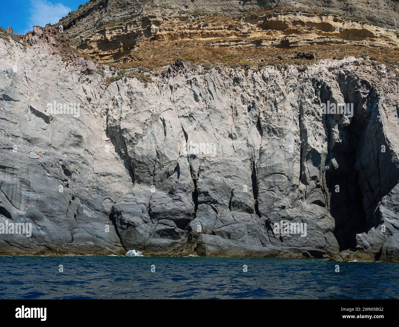 Weathered seaside rock face texture. Aged volcanic stone wall surface ...