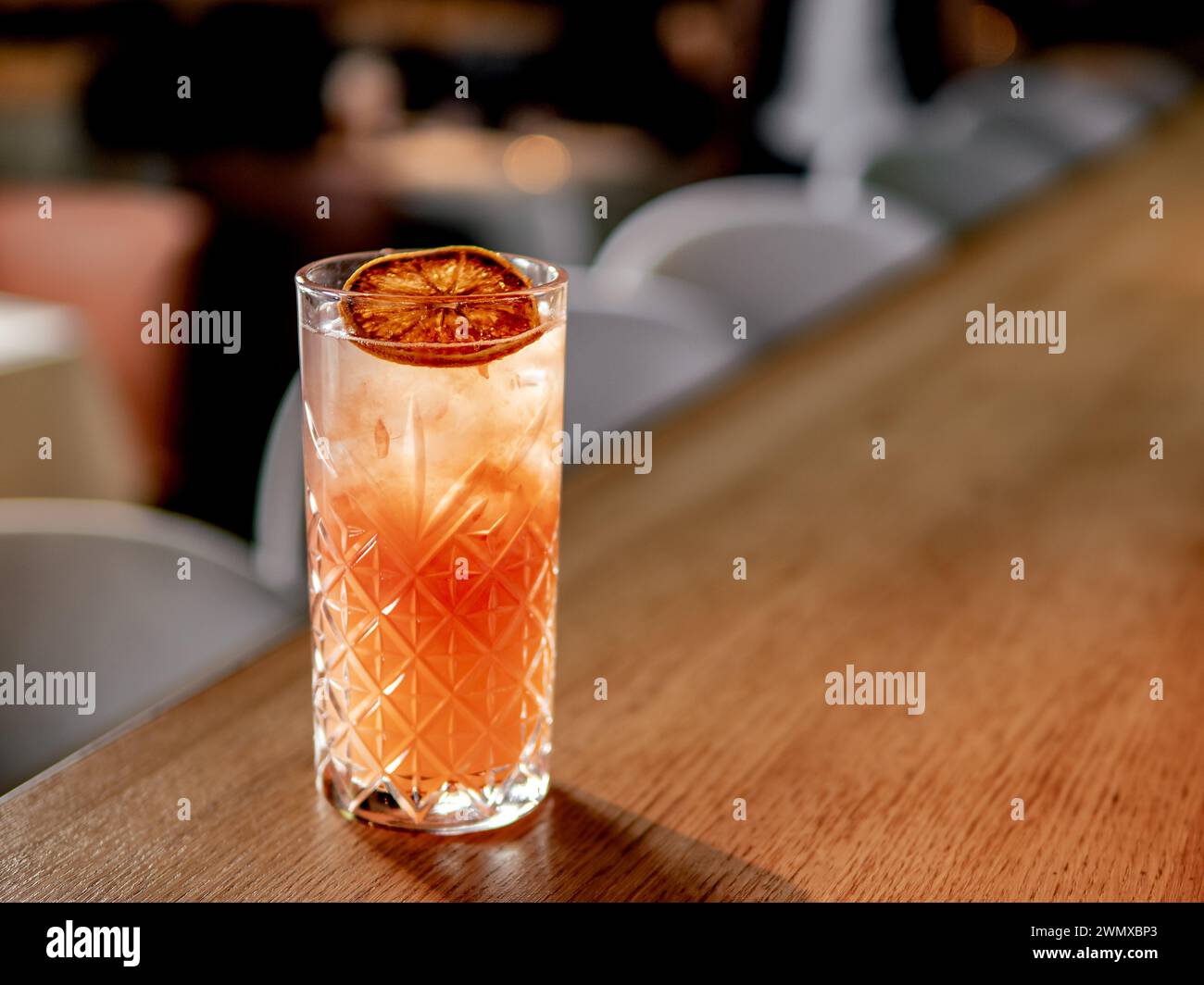 Glass of frozen citrus cocktail with triple sec on bar counter in ...