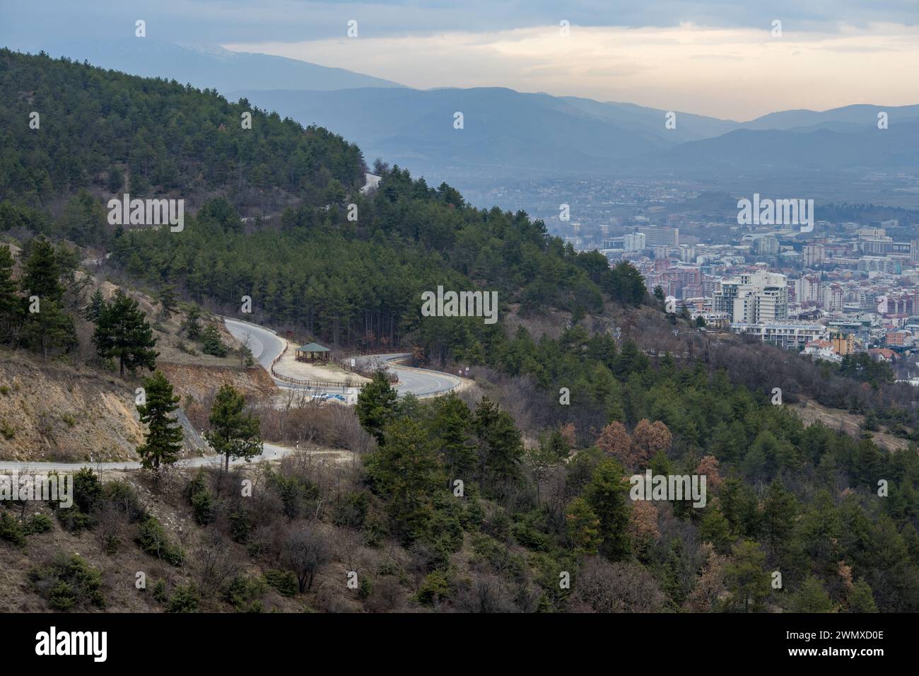 European mountain city seen from above at sunset on a cloudy day ...